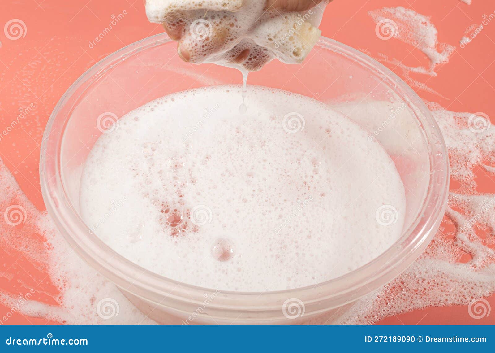 A Basin with Soapy Water, Hand Holds Soapy Sponge with Foam on Pink ...