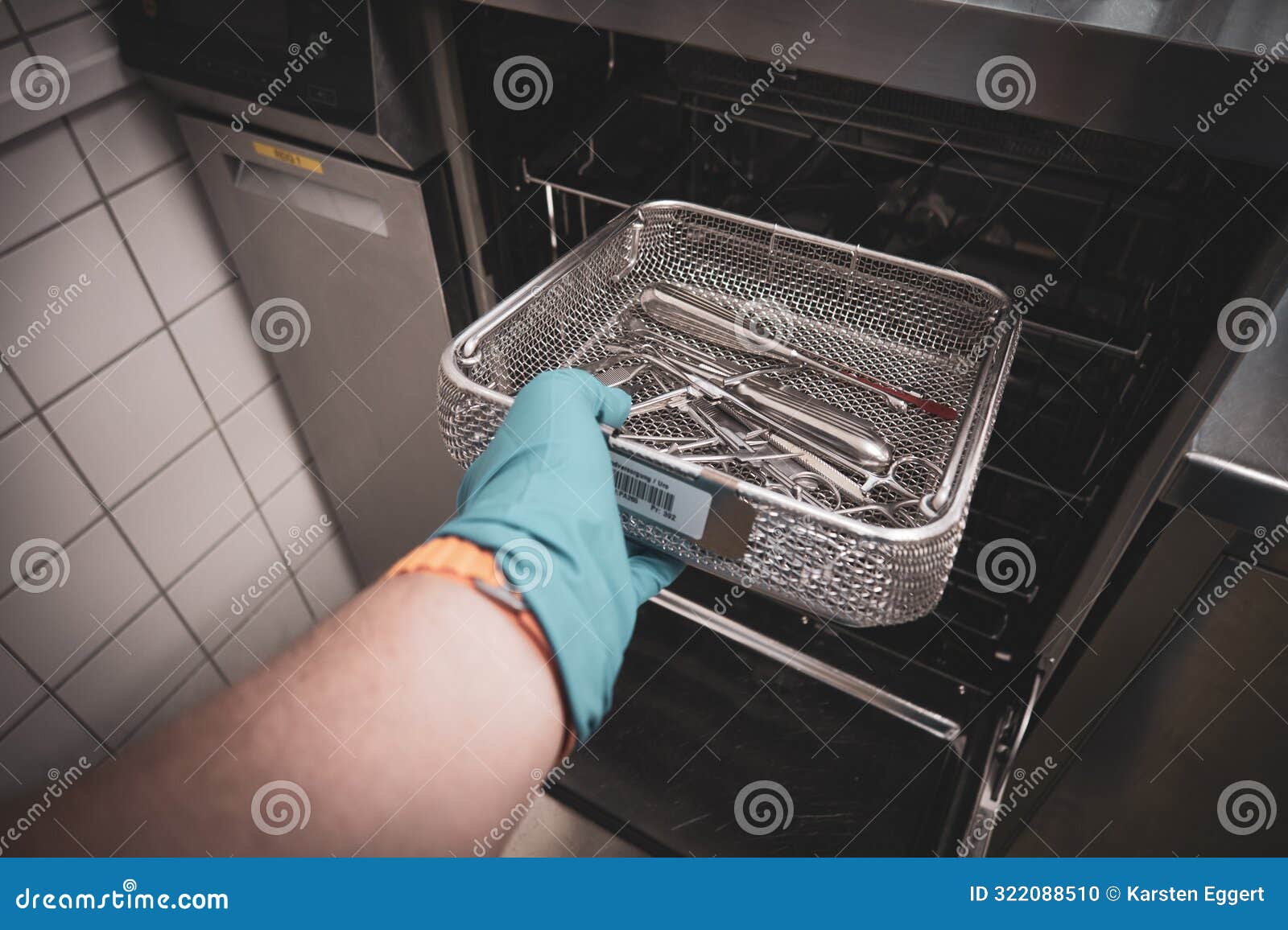 A Basket with Surgical Instruments is Placed in a Cleaning Machine ...