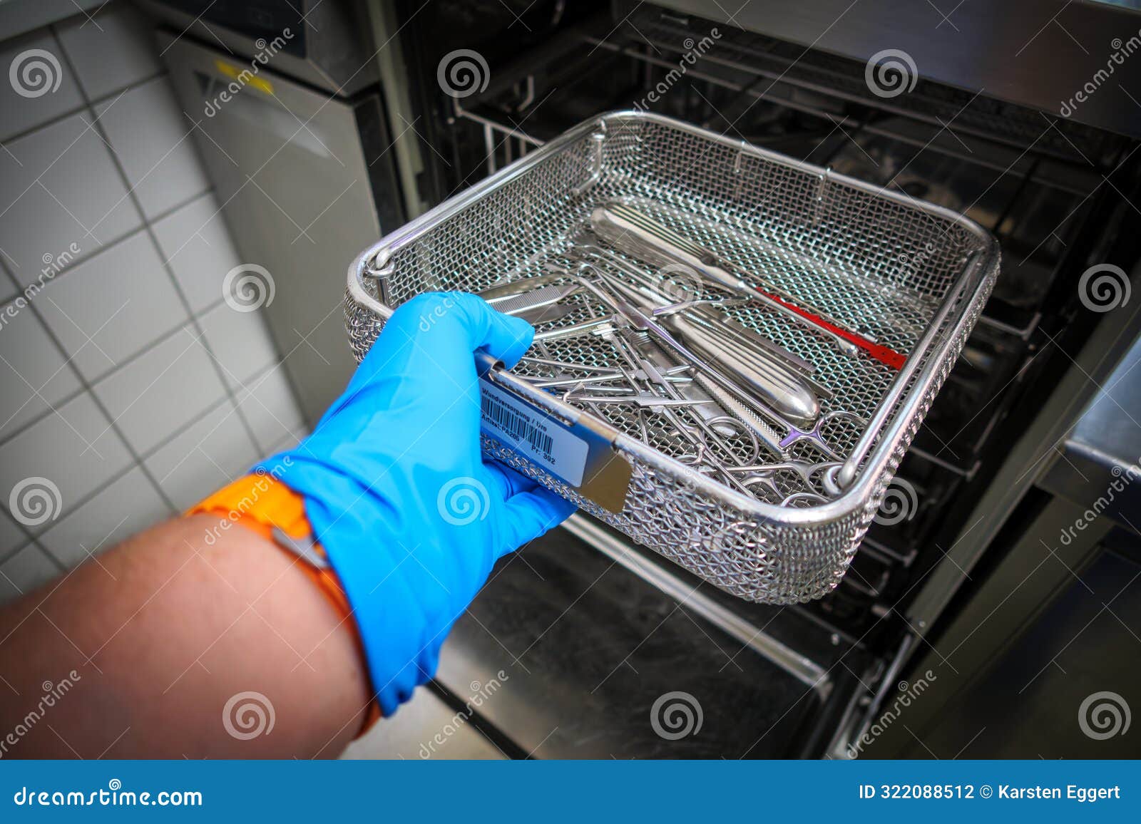 A Basket with Surgical Instruments is Placed in a Cleaning Machine ...