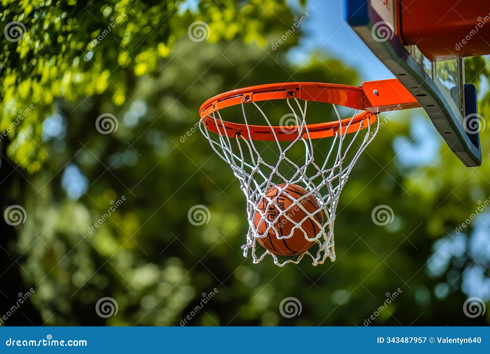 A Basketball Going through the Hoop of a Basketball Hoop Stock Image ...