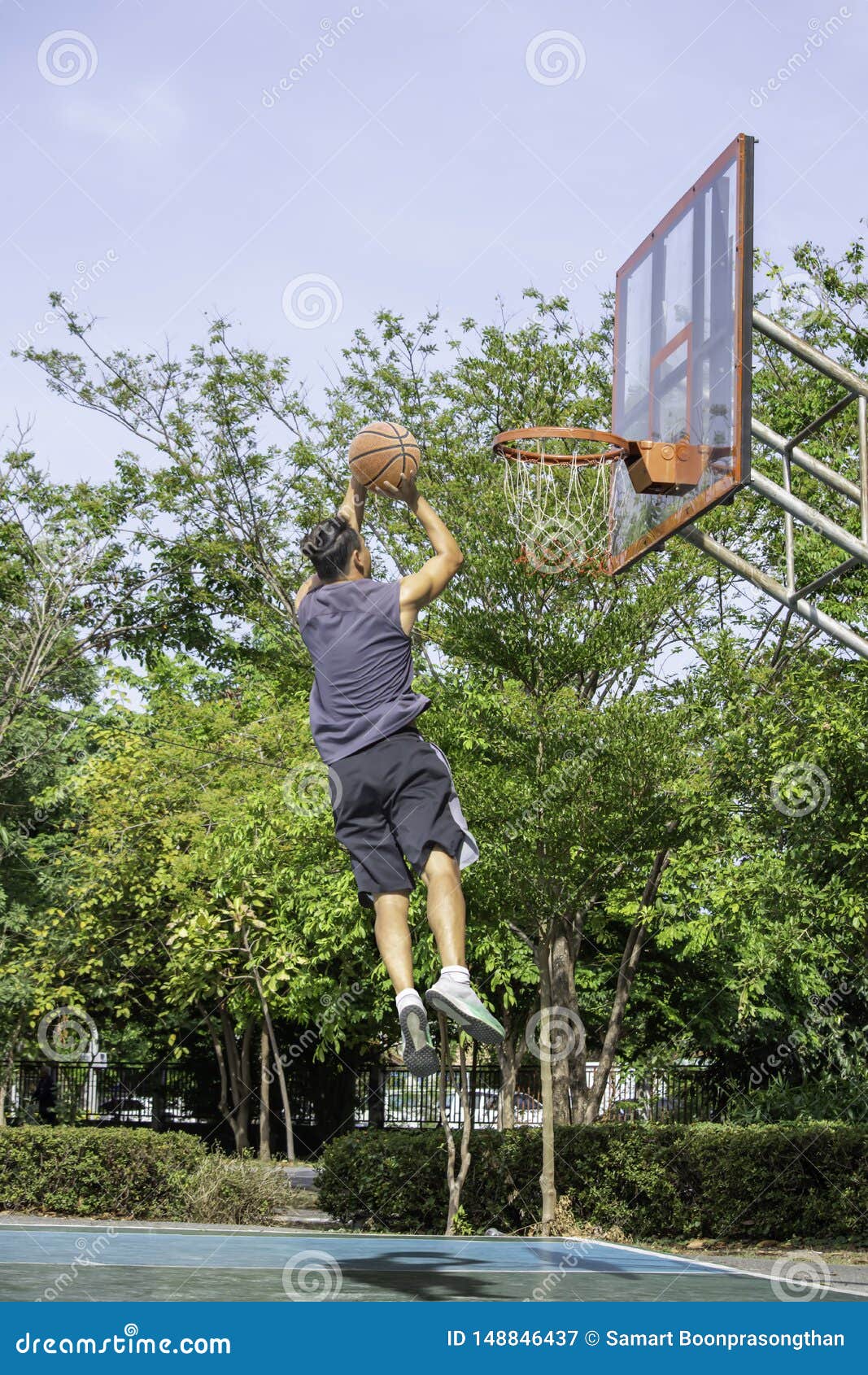 Basketball In Hand Man Jumping Throw A Basketball Hoop On The Wooden ...