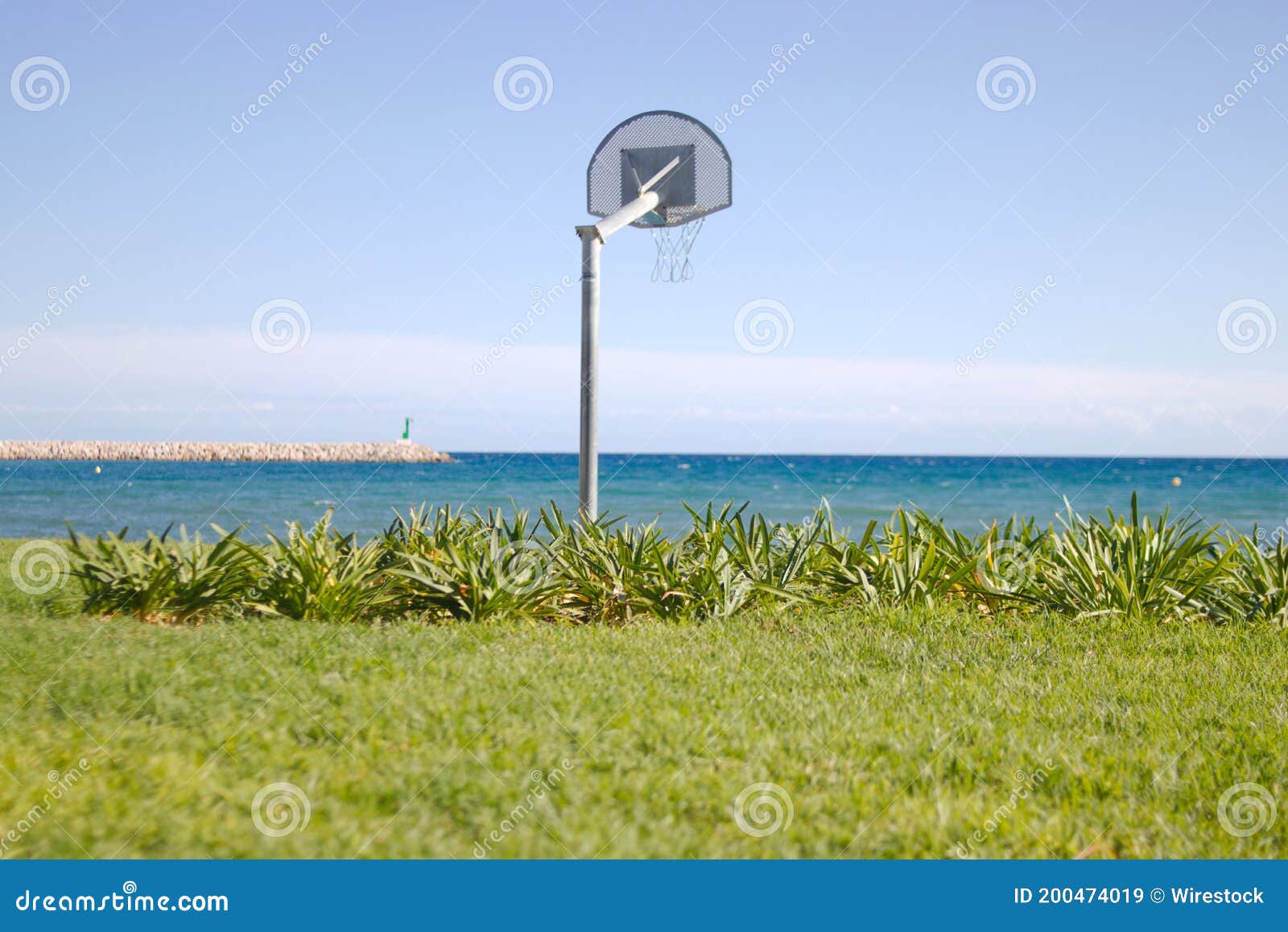 Basketball Hoop on a Grassy Beach with a Seascape View in Front Stock ...