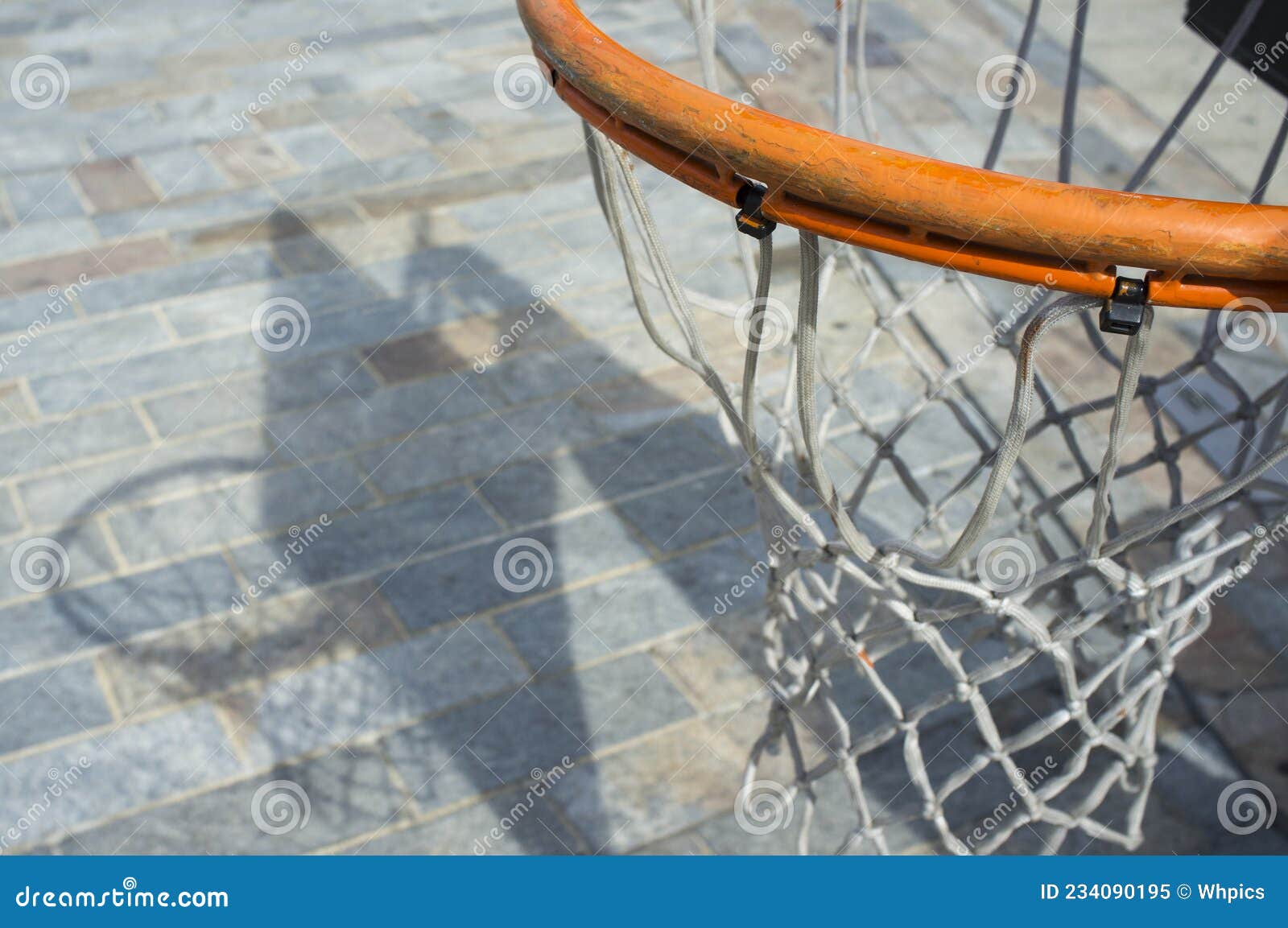 Basketball Hoop Proyecting Shadow Over Cobble Stone Road Surface Stock ...