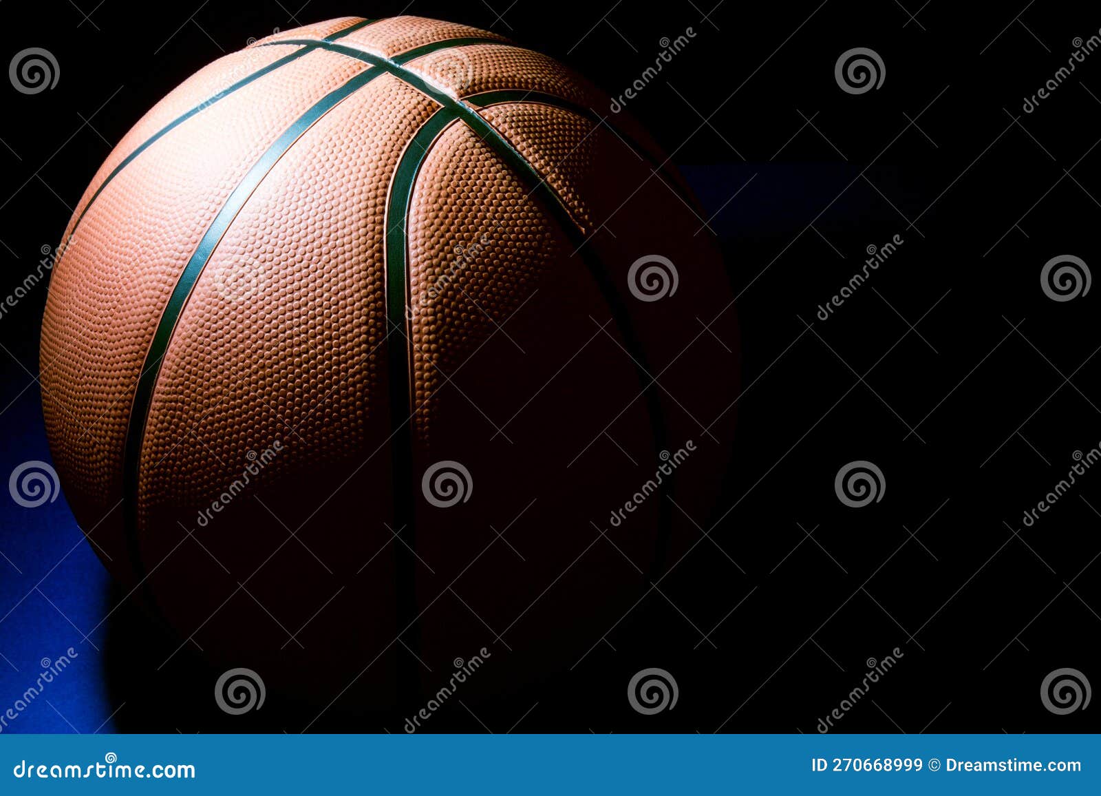 Basketball in Partial Shade on a Blue Surface Stock Image - Image of ...