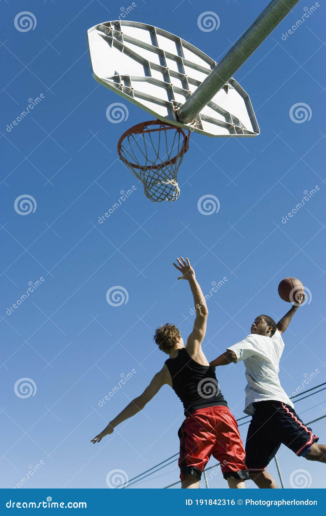 Basketball Player Guarding Another As he Tries To Shoot Basketball Low ...