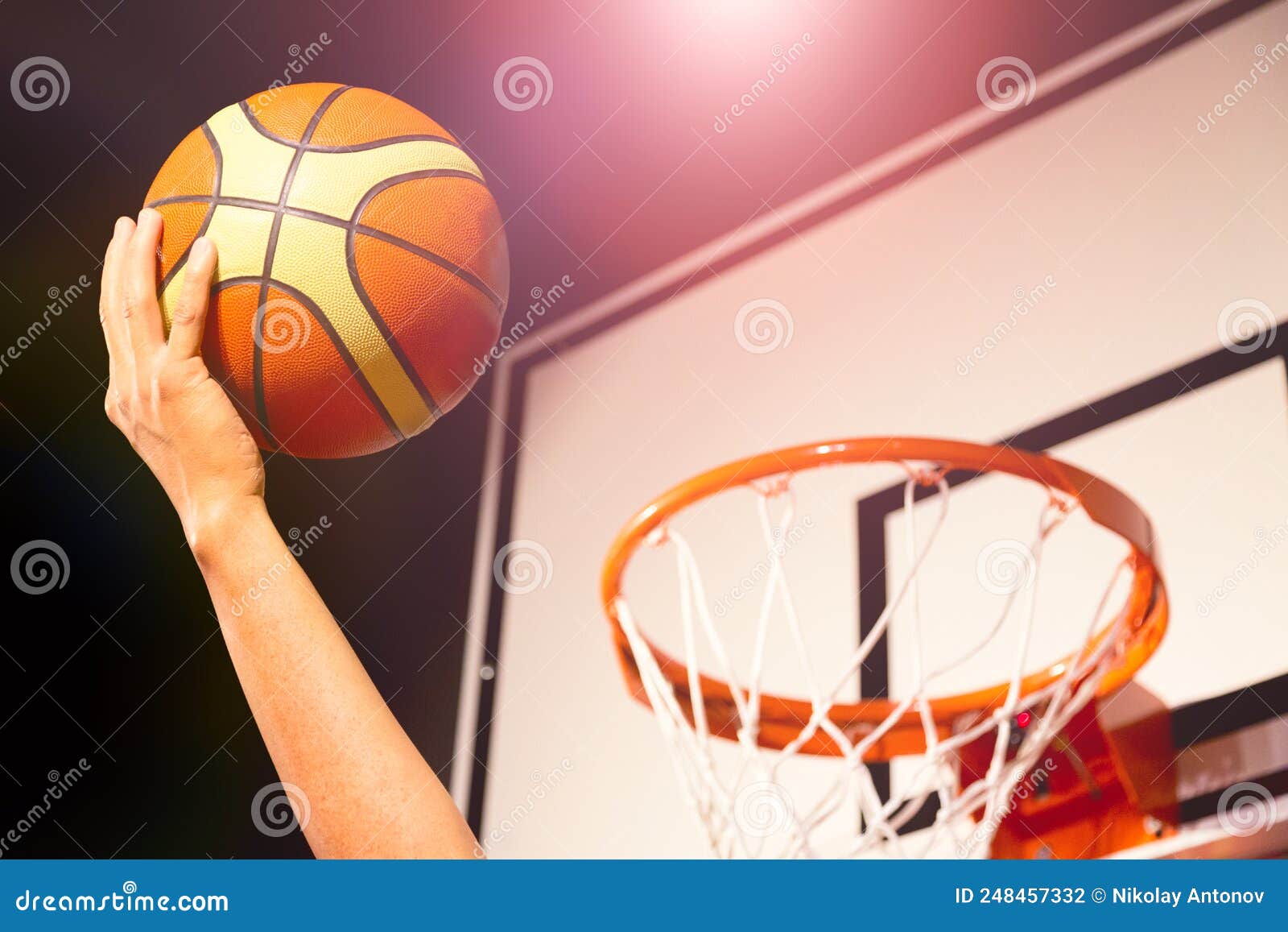 Basketball Player Putting Basketball Ball into the Hoop in Air Stock ...