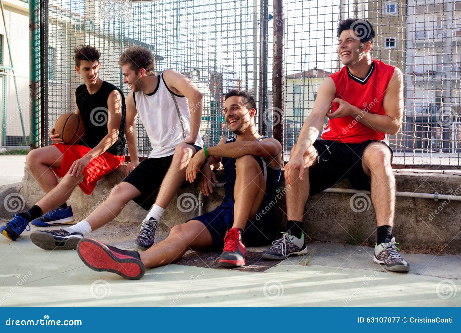 Basketball Players Take a Break Sitting on a Low Wall Stock Image ...