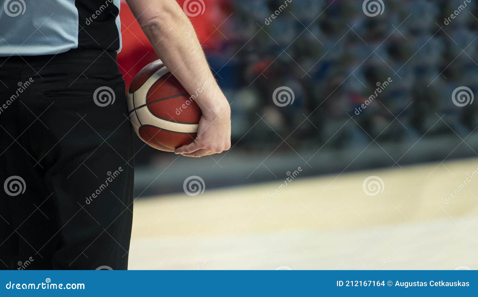 Basketball Referee Holding Ball At A Basketball Game During A Timeout ...