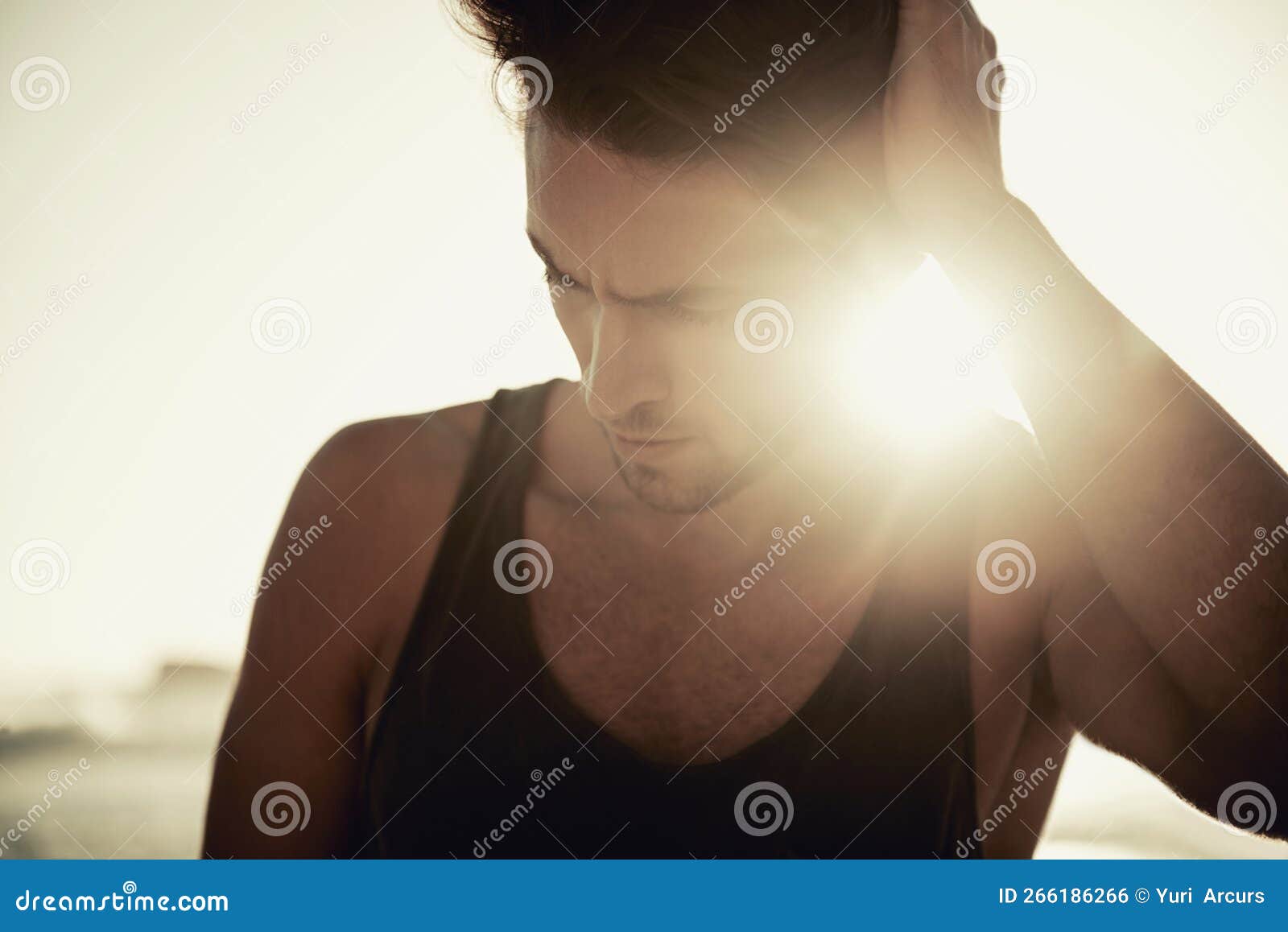 Basking in the Sunlight. a Handsome Man Standing on the Beach at Sunset ...