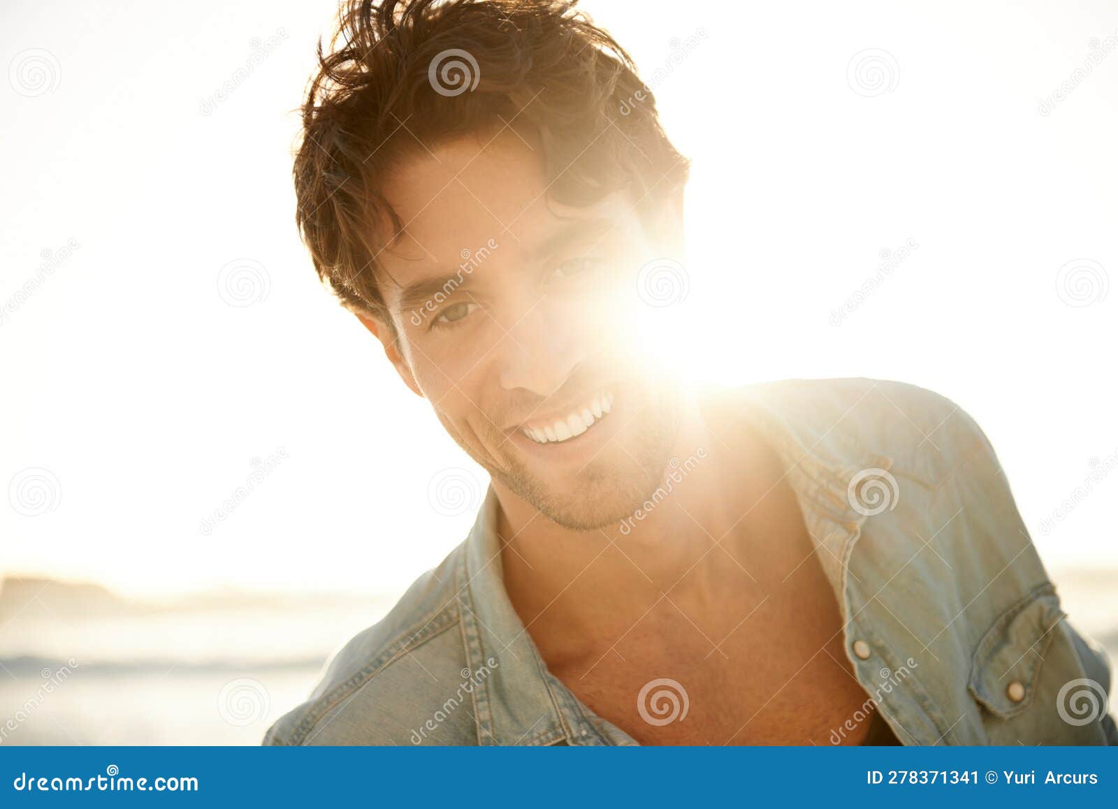 Basking in the Sunlight. a Handsome Man Standing on the Beach at Sunset ...