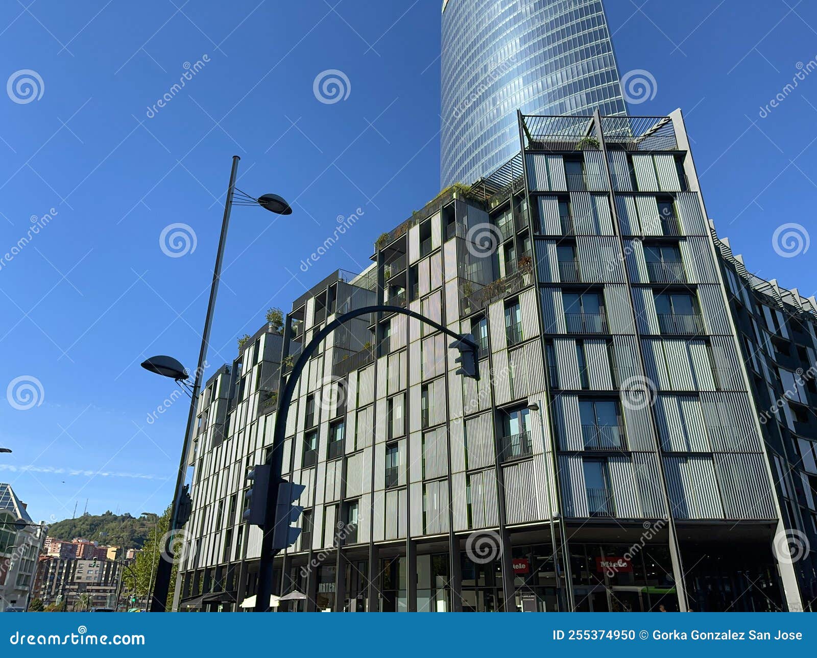 Basque Glass Industry Tower in Bilbao`s Tree-lined Park with Modern ...