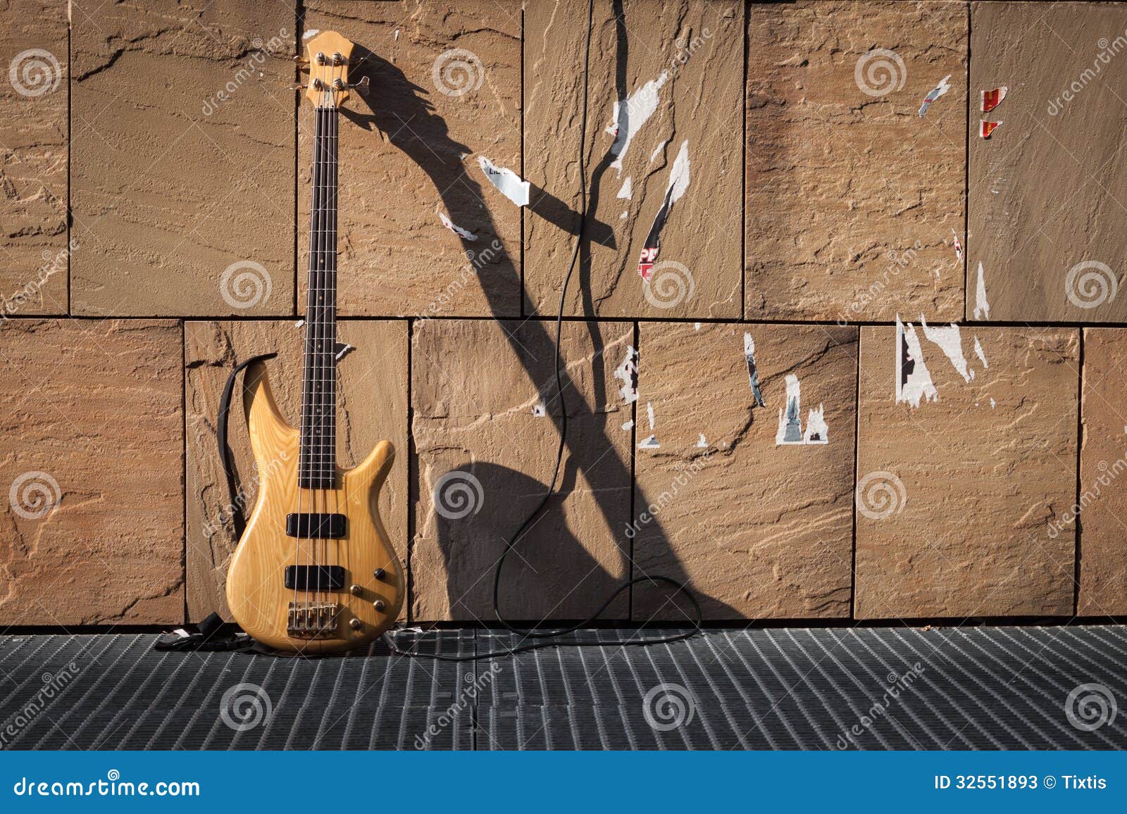 Bass guitar against a wall stock image. Image of guitar - 32551893