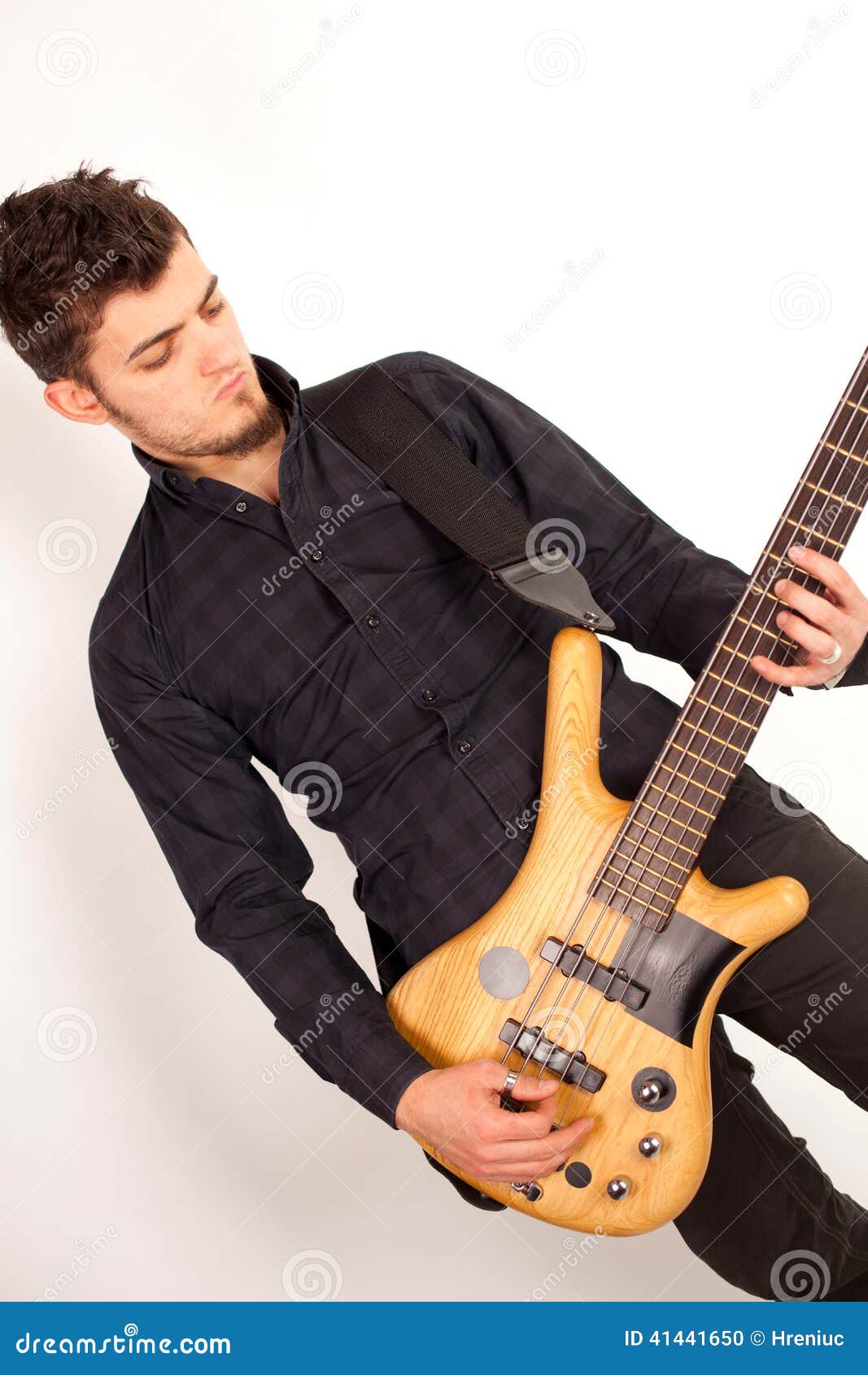Bass Player Looking at His Instrument Stock Photo - Image of hair ...