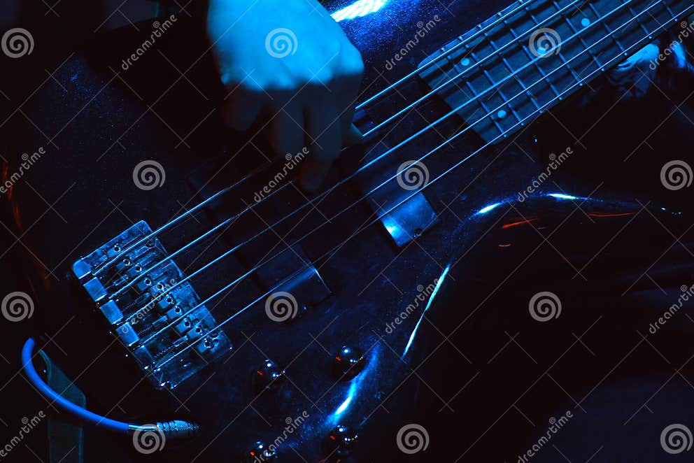 The Bass Player Plays a Five-string Bass Guitar Stock Photo - Image of ...