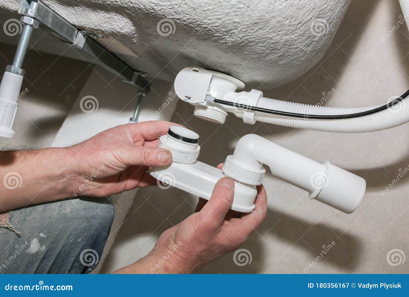 Bath Installation. Worker is Making Drain with Hose Tube. Maintenance ...