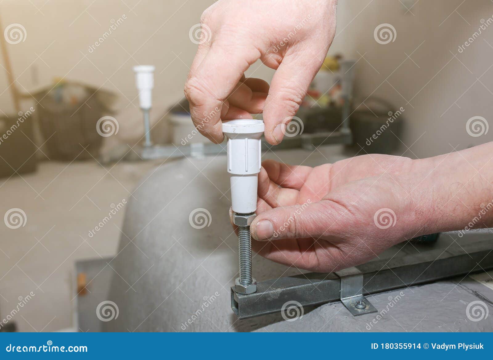 Bath Installation. Worker is Making Fastener. Maintenance Repair in the ...