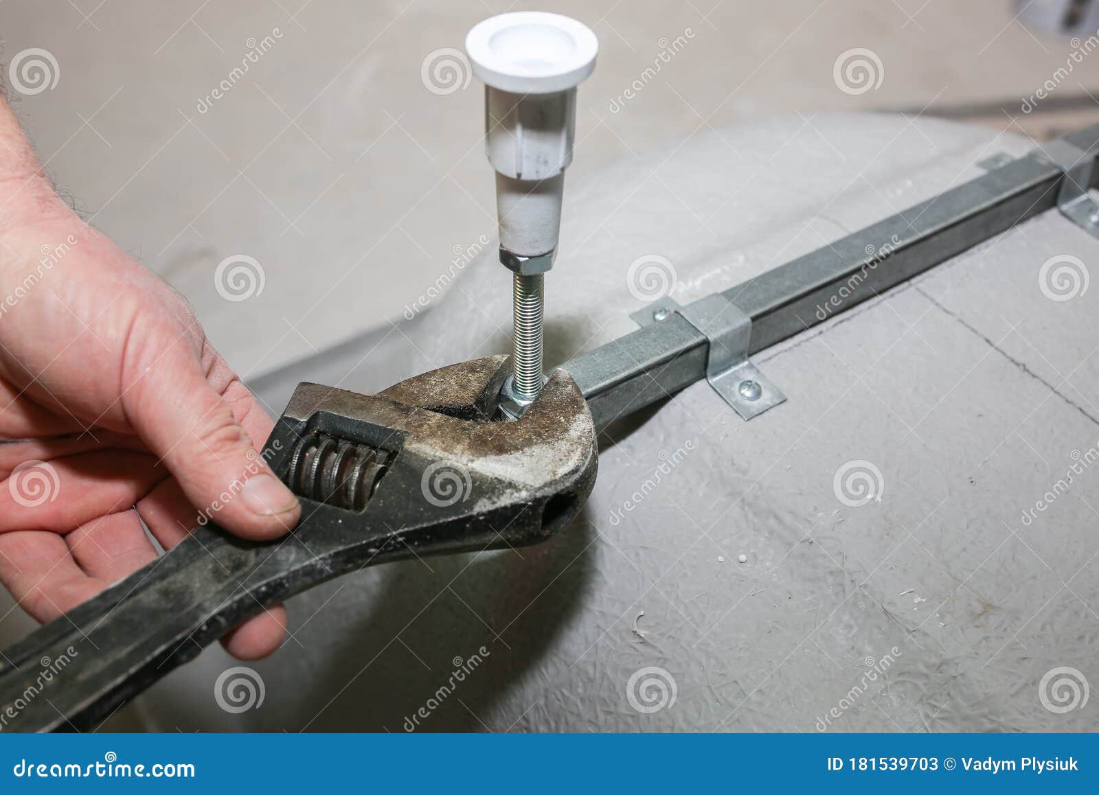 Bath Installation. Worker is Making Fastener with Wrench. Maintenance ...
