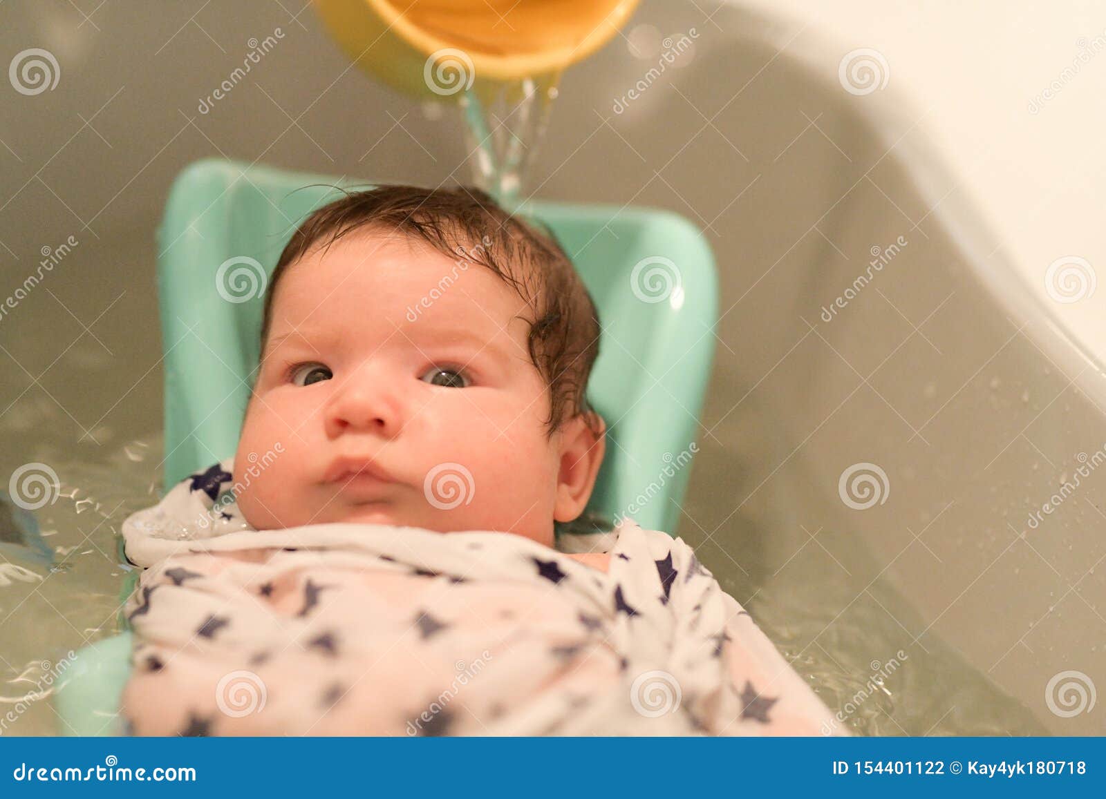 Bathing a Baby. Bathes Her Son in a Small Plastic Bath Stock Photo ...
