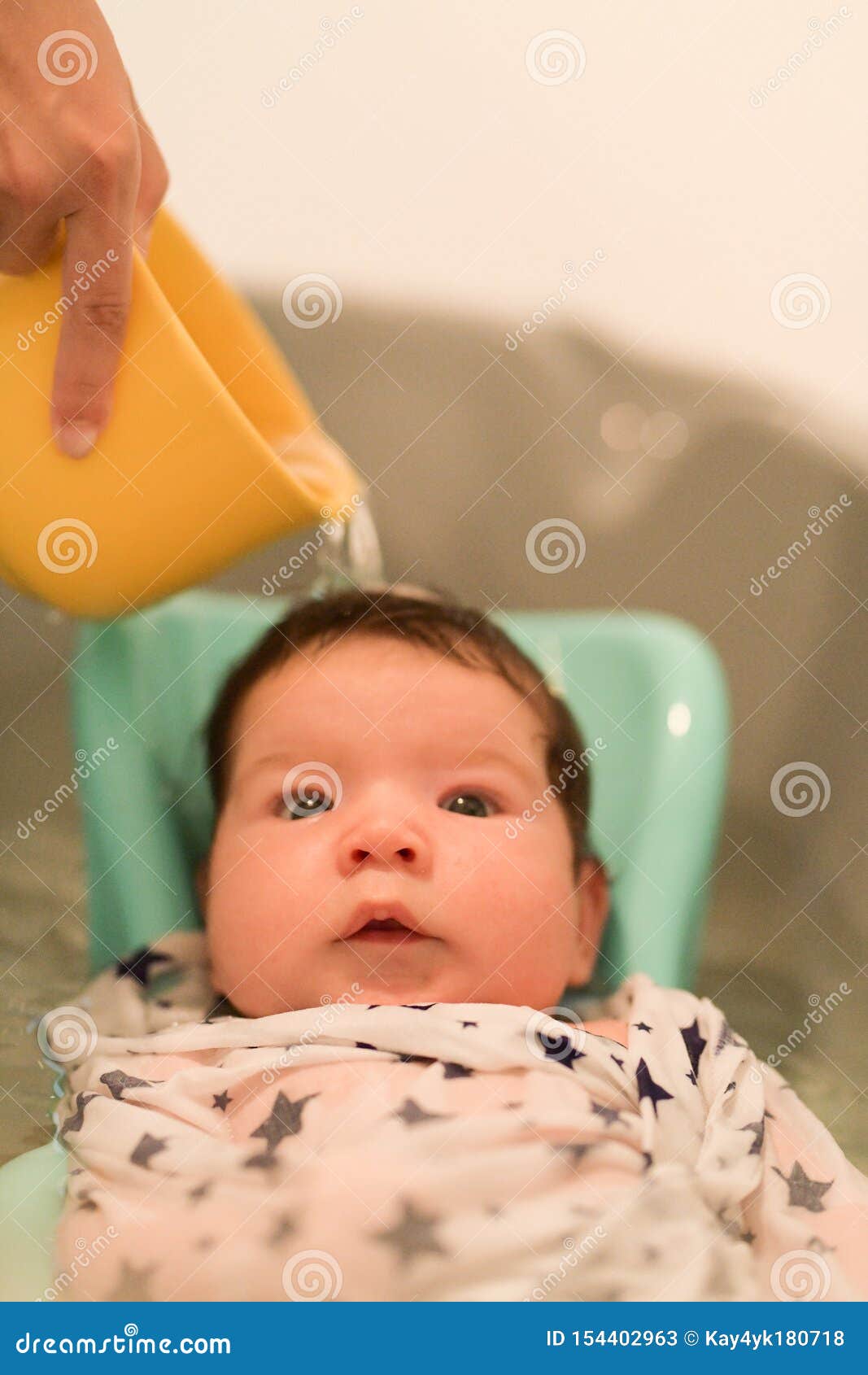 Bathing a Baby. Bathes Her Son in a Small Plastic Bath Stock Image ...
