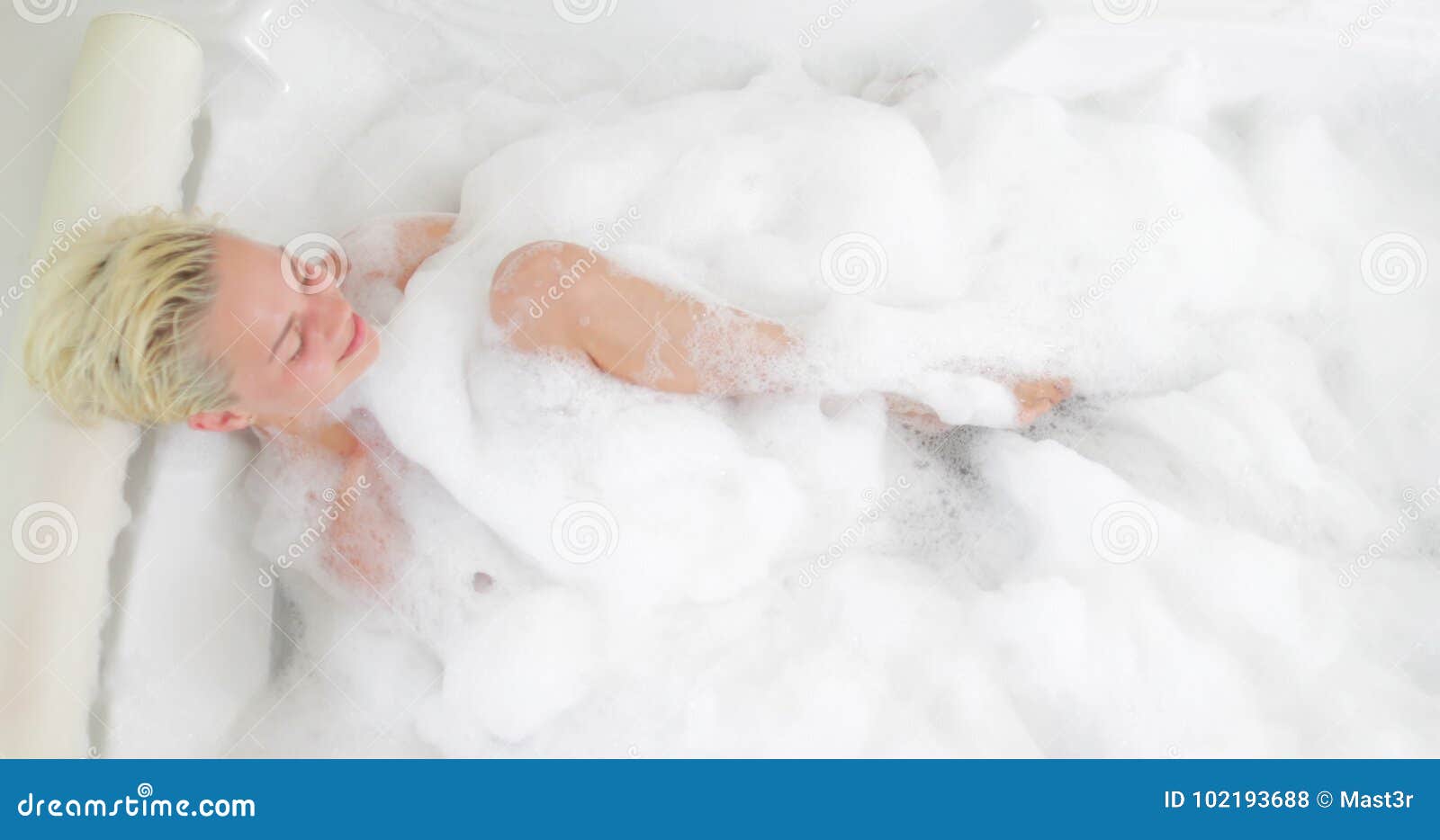 Bathing Young Woman Relaxing In Bath Full Of Foam Raising Legs Top