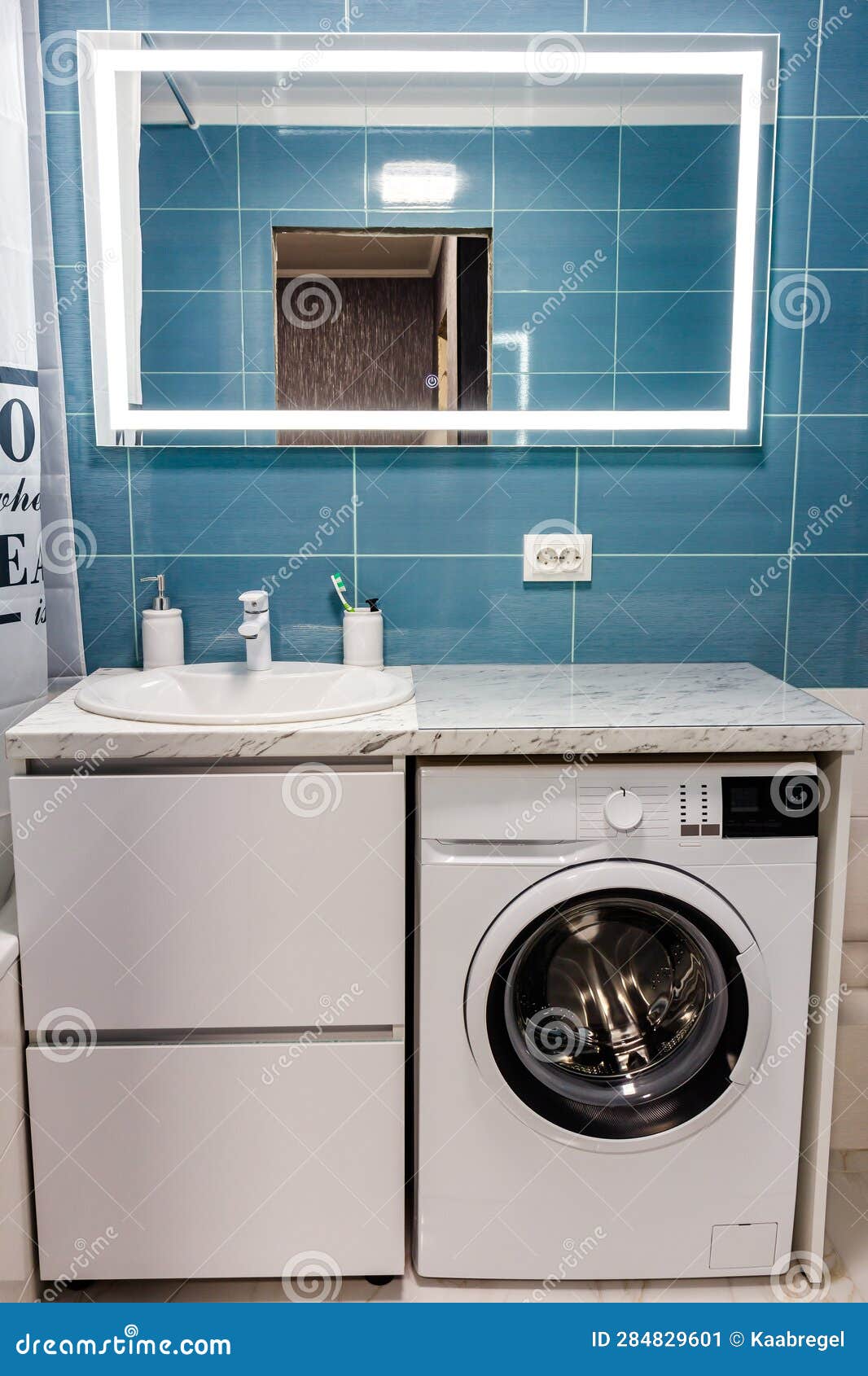 Bathroom with Countertop Sink, Large Mirror and Washing Machine Stock ...