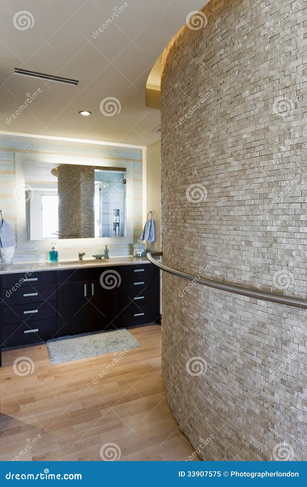 Bathroom with Curved Stone Wall and Cabinets Stock Image - Image of ...