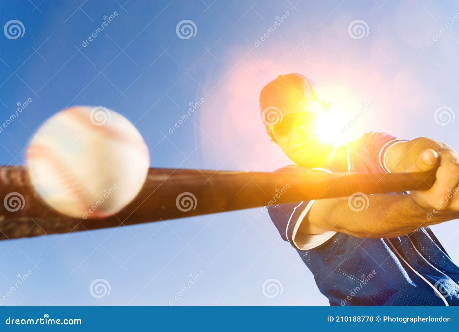 Batter Hitting Baseball on Sunny Day Stock Photo - Image of person ...