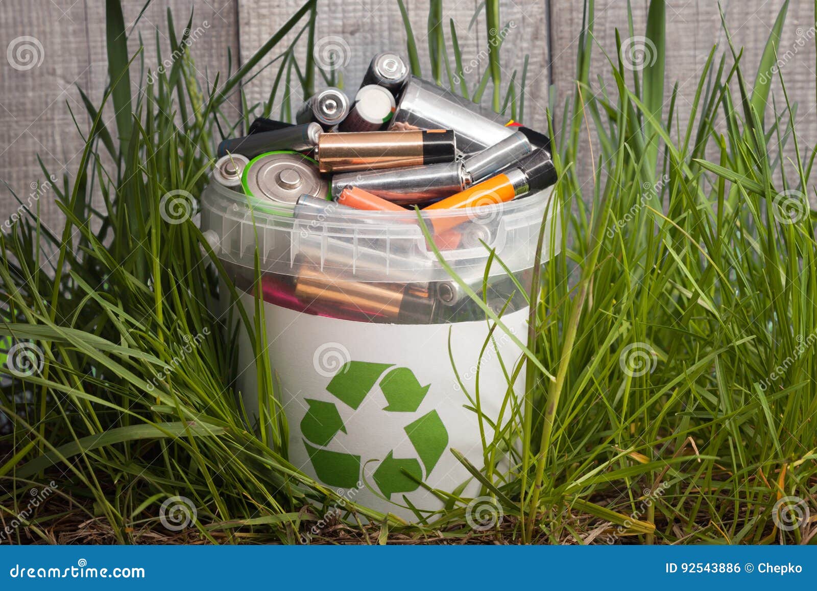 Battery Recycle Bin with Old Element on Wood Table in Grass Stock Photo ...
