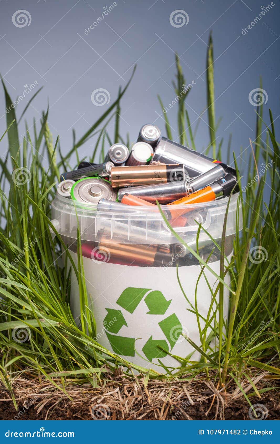 Battery Recycle Bin with Old Element on Wood Table in Grass Stock Photo ...