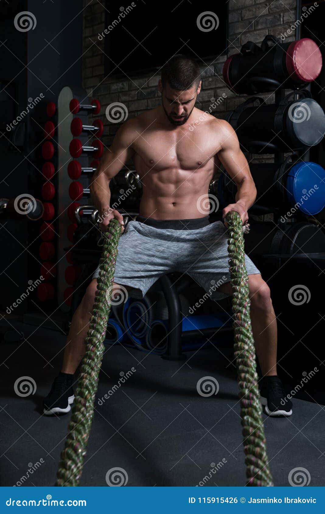 Young Man Battling Ropes at Gym Workout Exercise Stock Photo - Image of ...