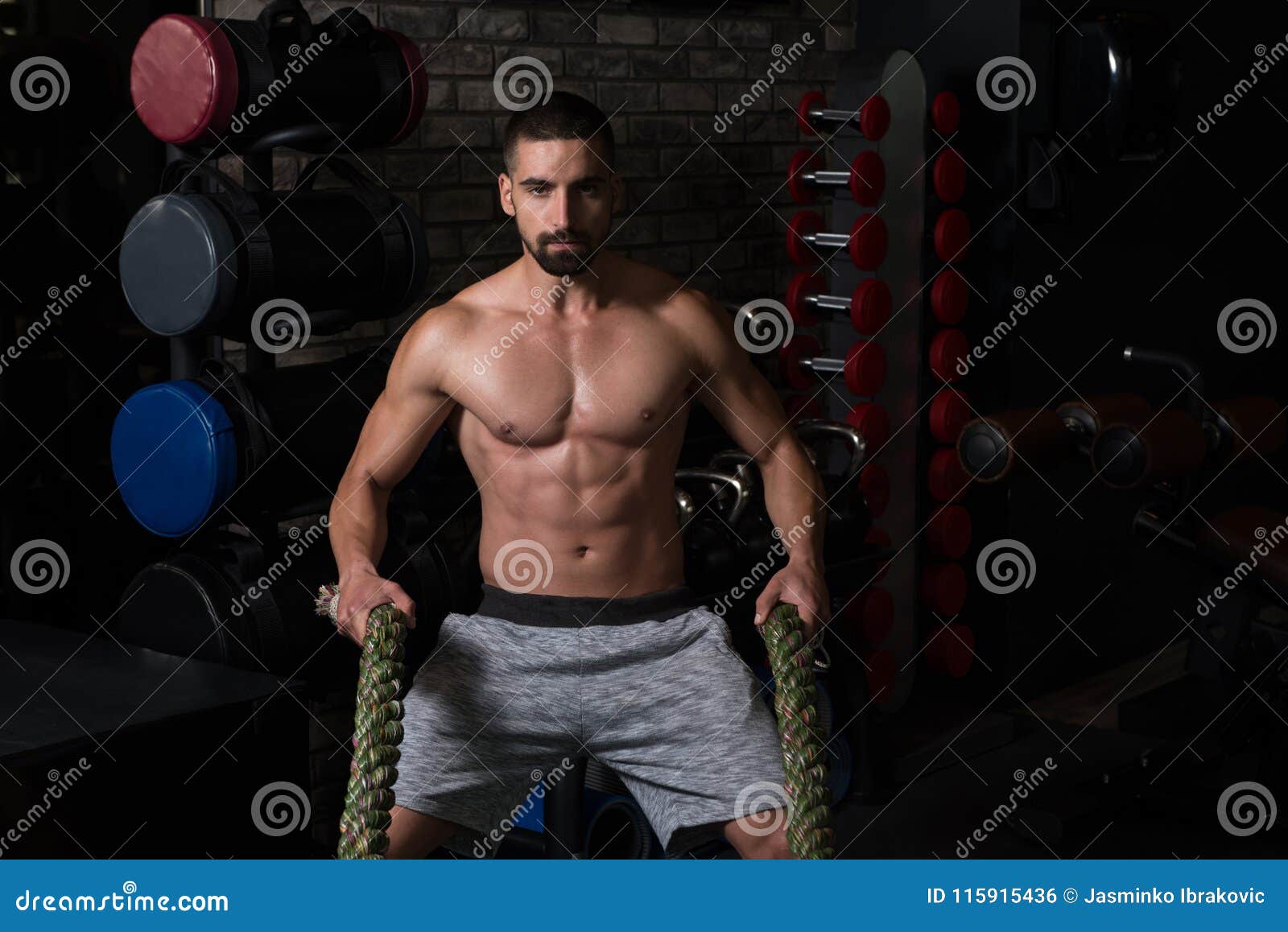 Young Man Battling Ropes at Gym Workout Exercise Stock Photo - Image of ...