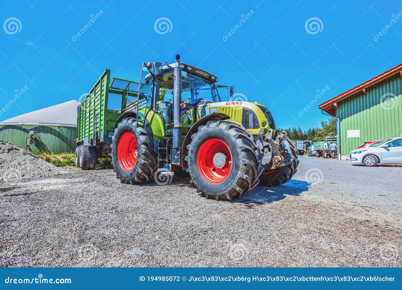 Claas Tractor Working On Meadow. Agriculture Industry And Business ...