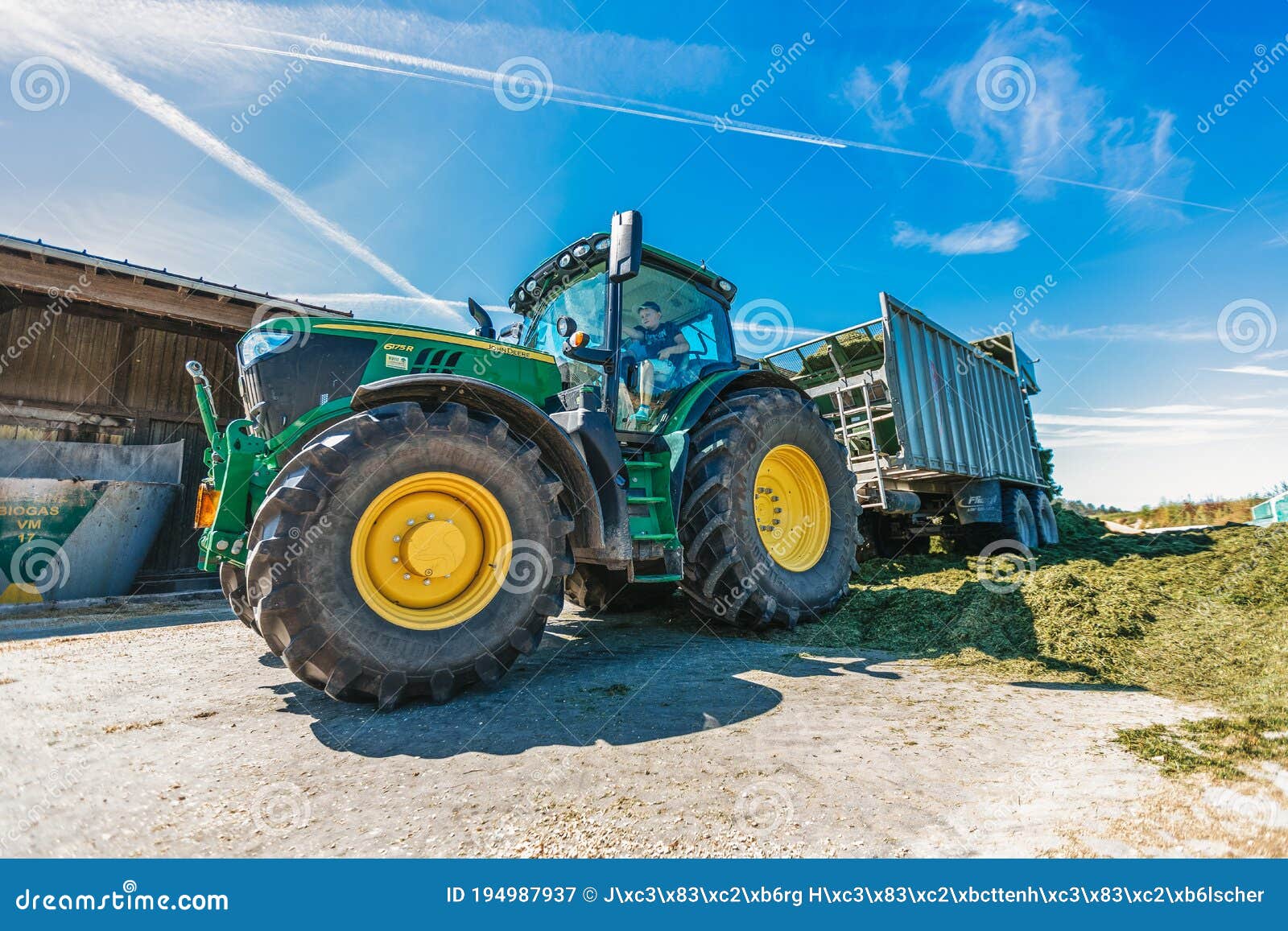 John Deere Tractor with a Loader Wagon, Working on a Biogas Plant ...
