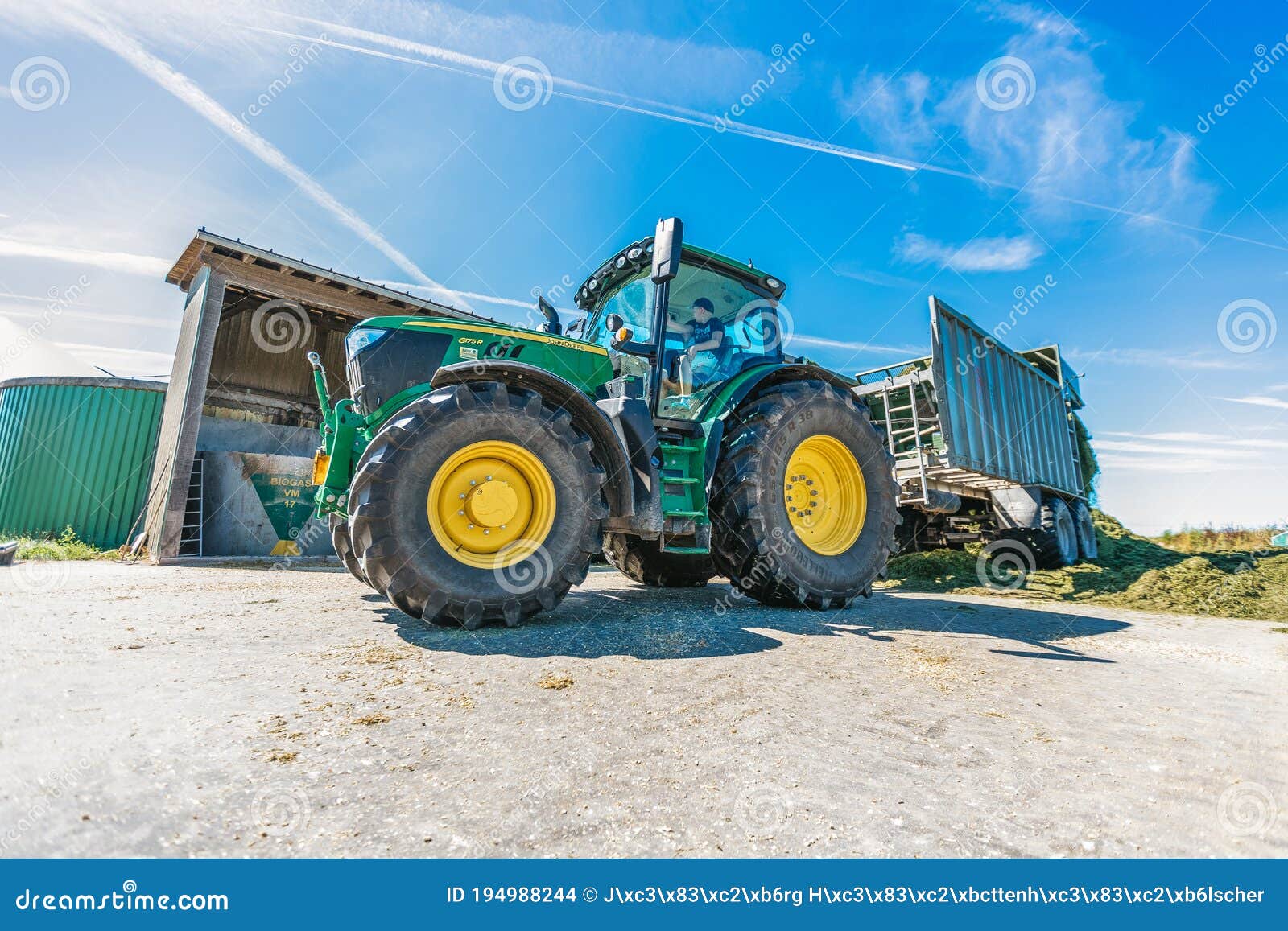 John Deere Tractor With A Loader Wagon, Working On A Biogas Plant ...