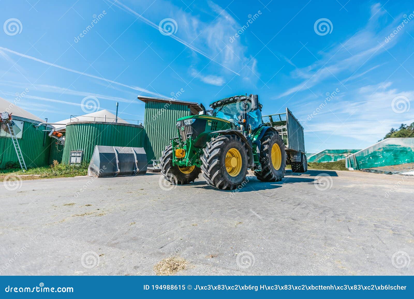 John Deere Tractor with a Loader Wagon, Working on a Biogas Plant ...