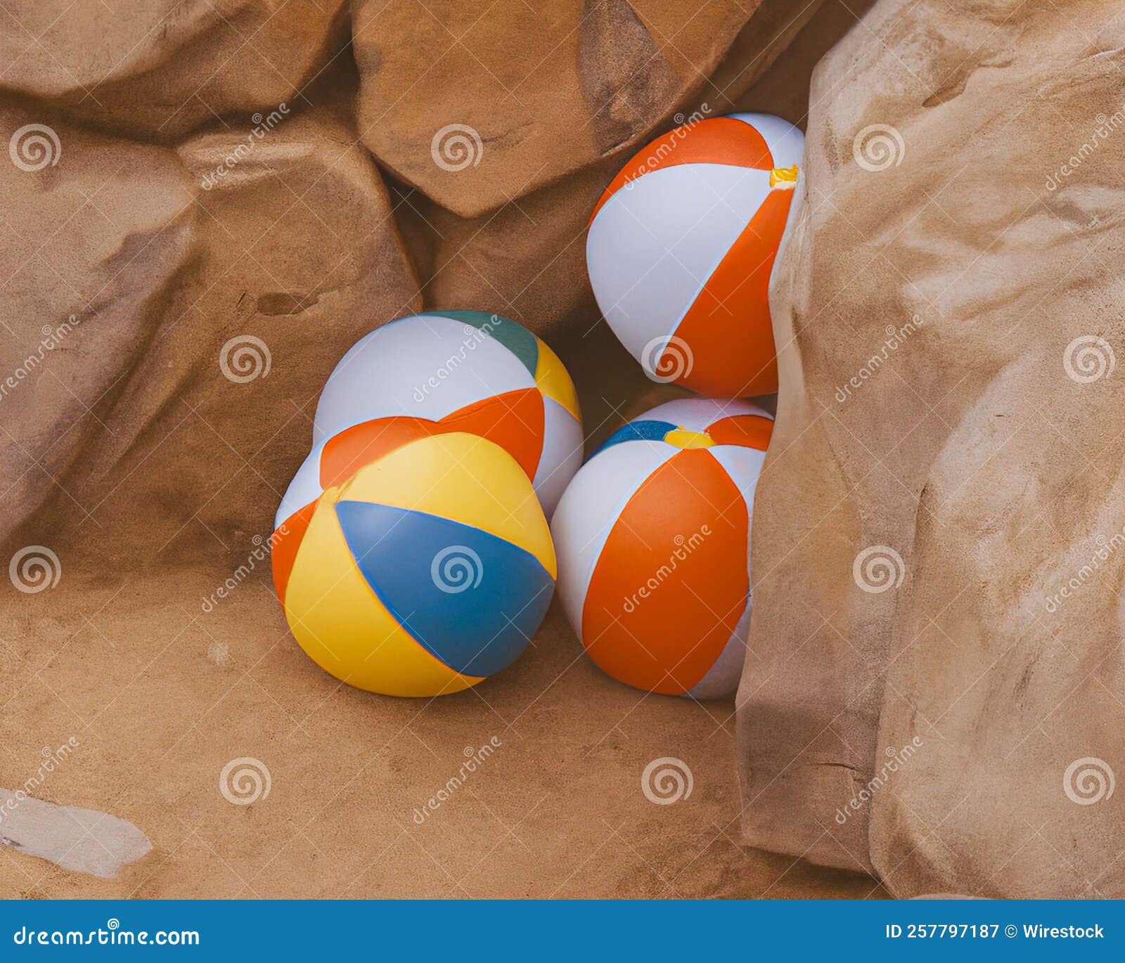 Beach Balls Stuck between Big Rocks at the Beach Stock Image - Image of ...