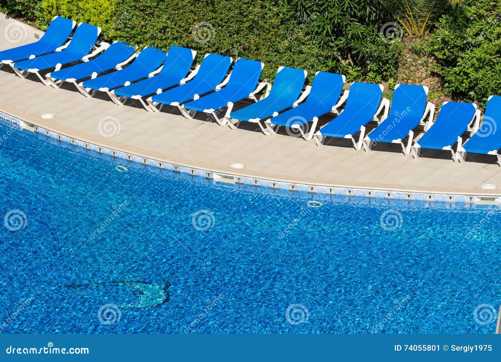 Beach chairs by the pool stock image. Image of recreation - 74055801
