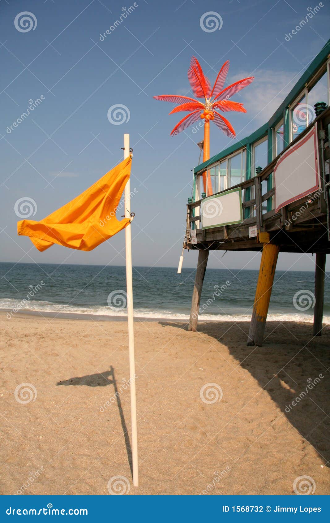 Beach Flag next to Pier stock photo. Image of surf, heat - 1568732
