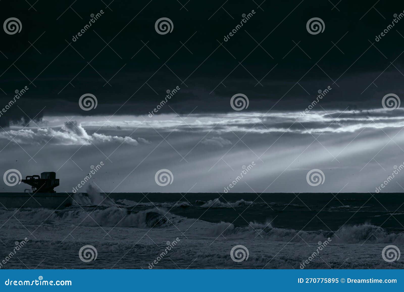 Beach in the Foreground with a Structure in the Distance Across the Sea ...