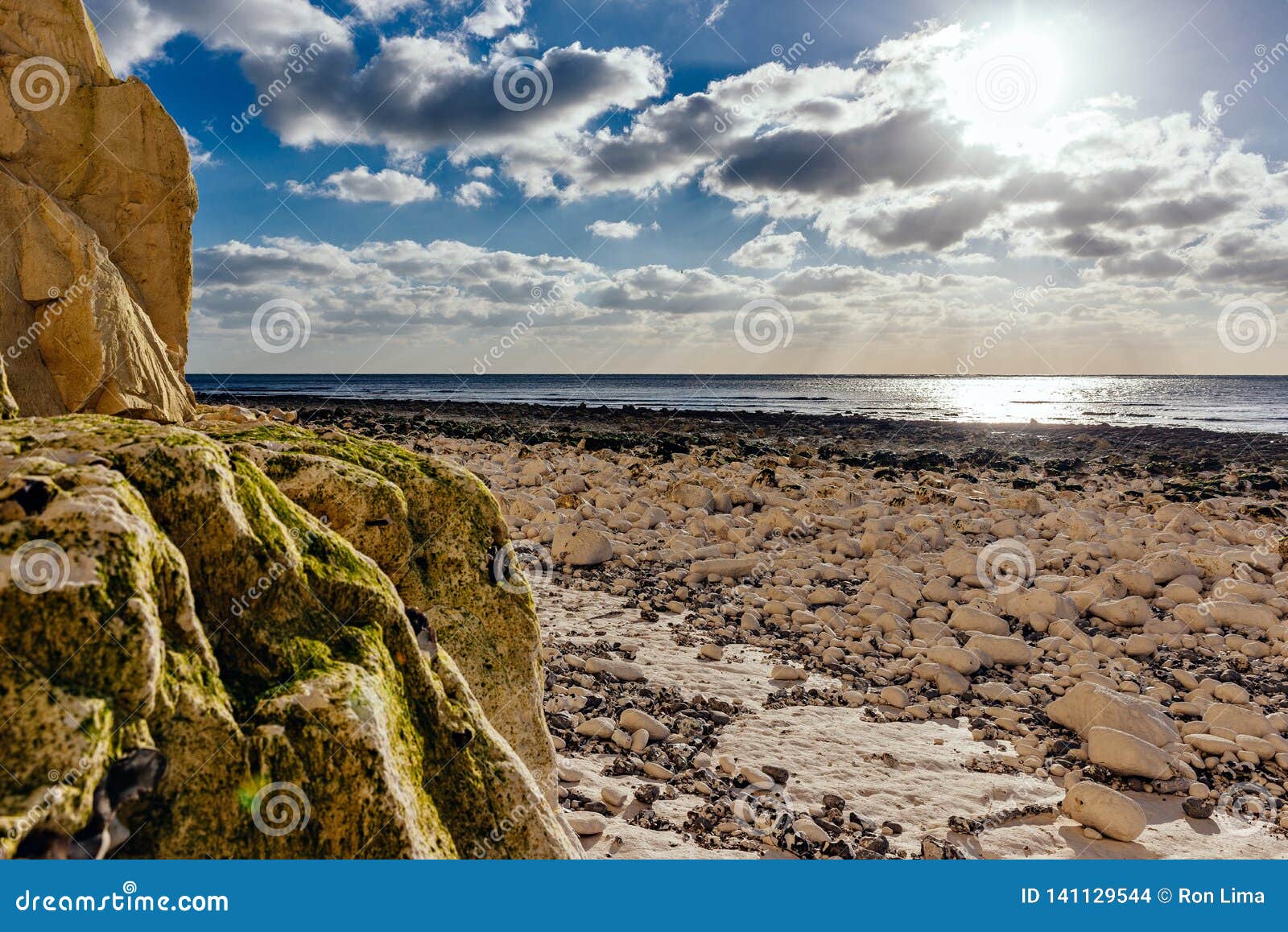 Calm beach full of rocks stock photo. Image of european - 141129544