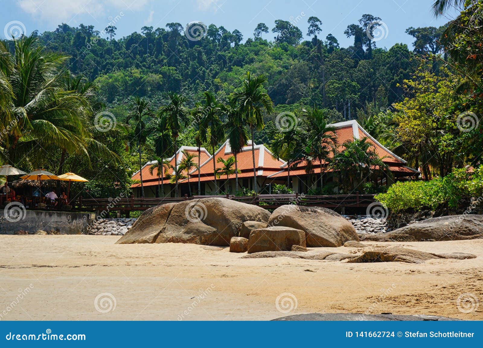 Beach with house and rocks stock photo. Image of relax - 141662724