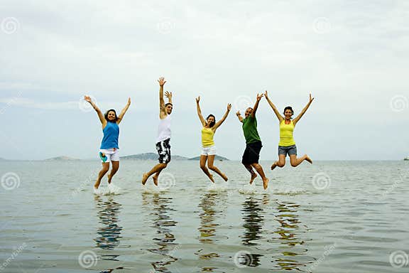 Beach Jumping stock photo. Image of friend, holiday, beach - 14826592