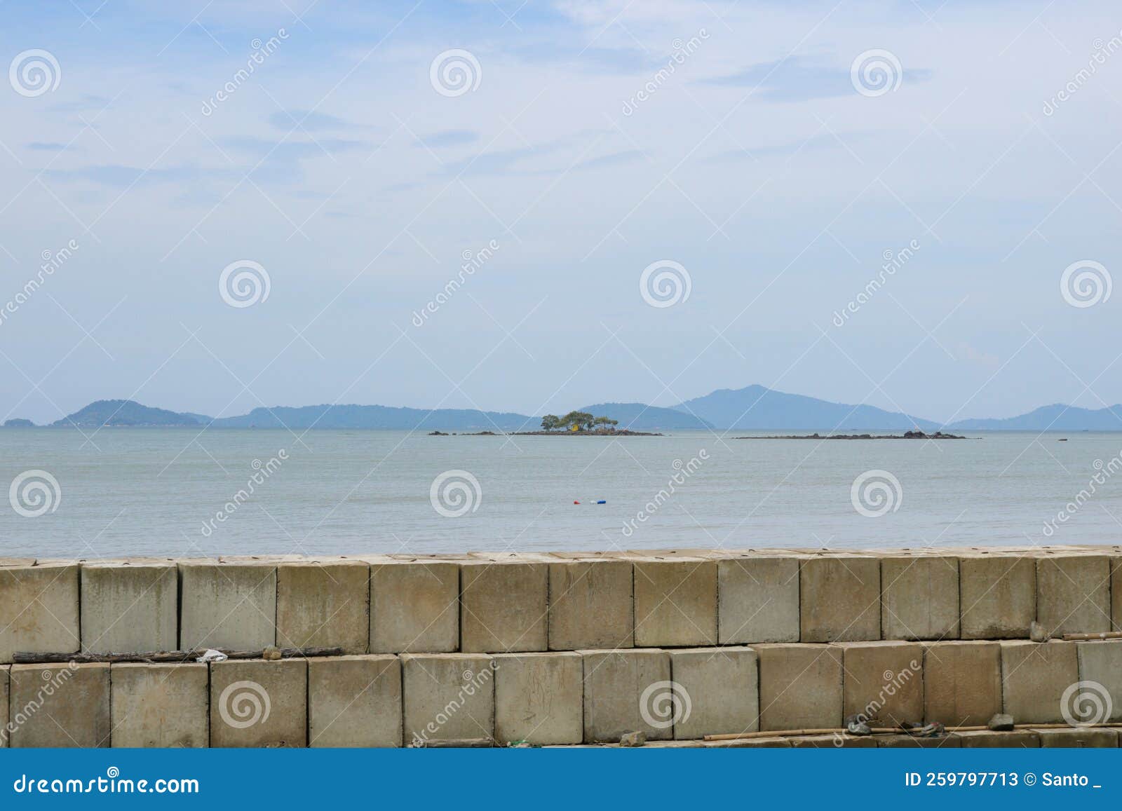 Beach Landscape with Island and Blue Sky, Concrete Wall in Front of the ...