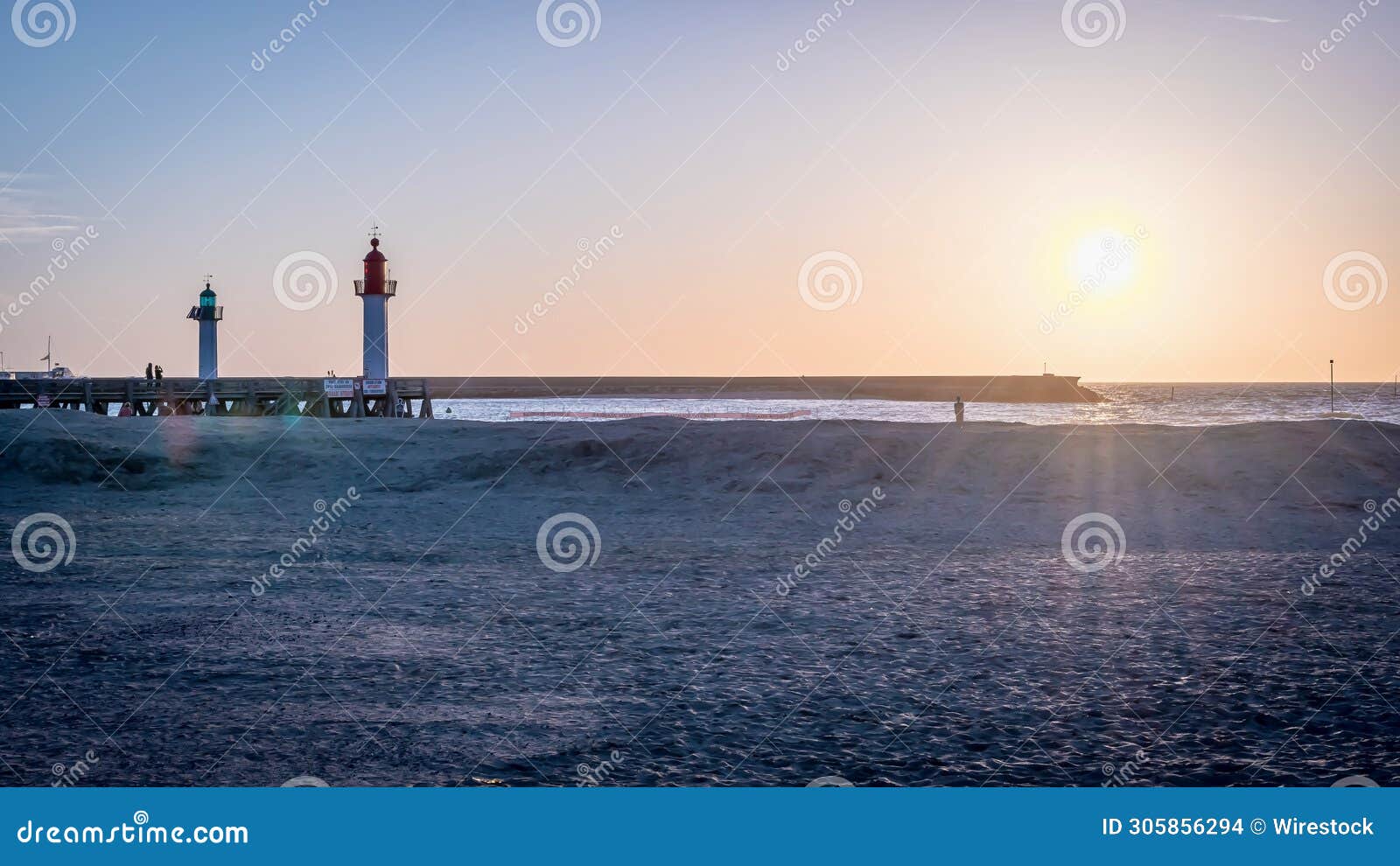 Beach Lighthouses Illuminated by a Vibrant Sunrise Stock Photo - Image ...