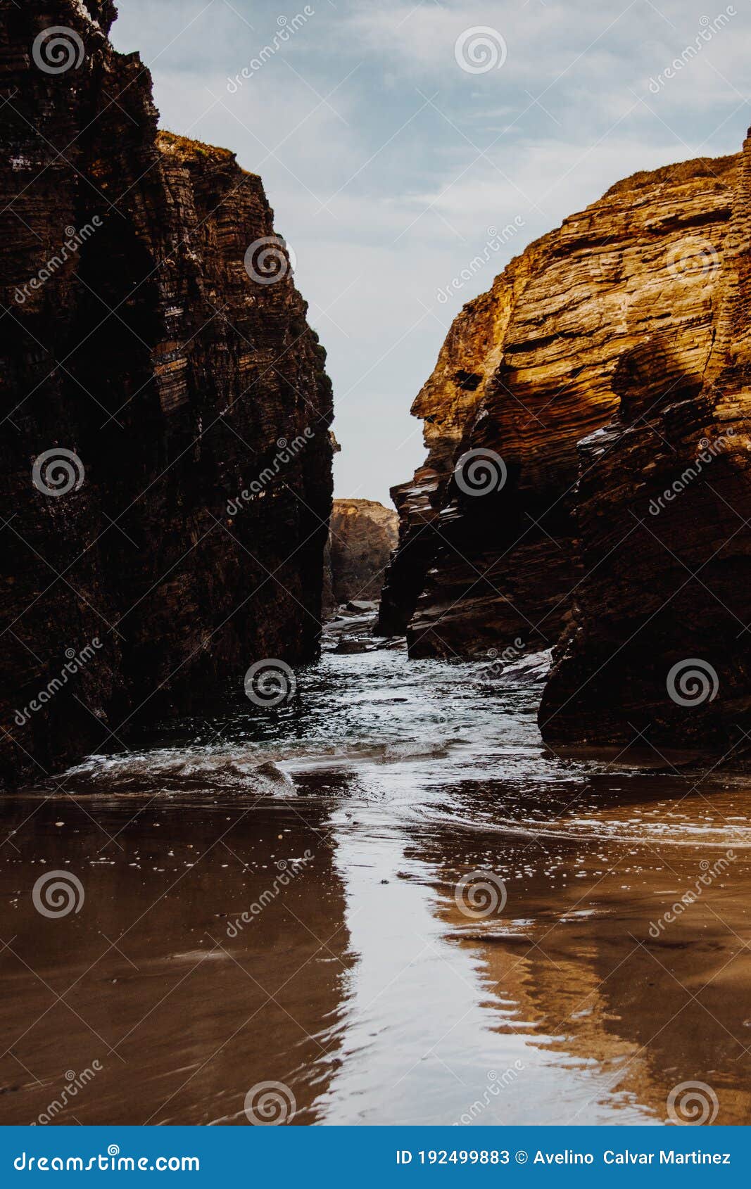A Beach in the Middle of Two Giant Rocks Stock Image - Image of sunset ...