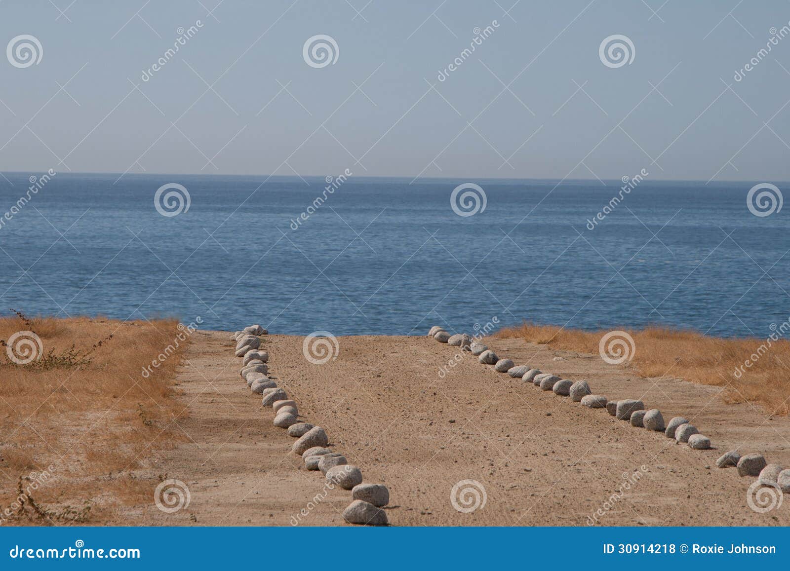 Stone lined path on beach stock photo. Image of beach - 30914218