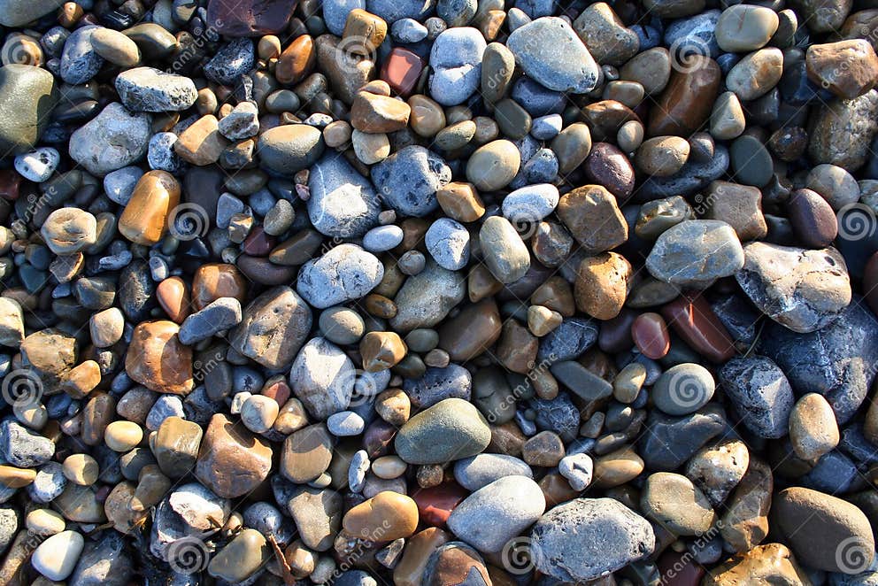 Beach pebbles in sunlight stock image. Image of infinity - 382305