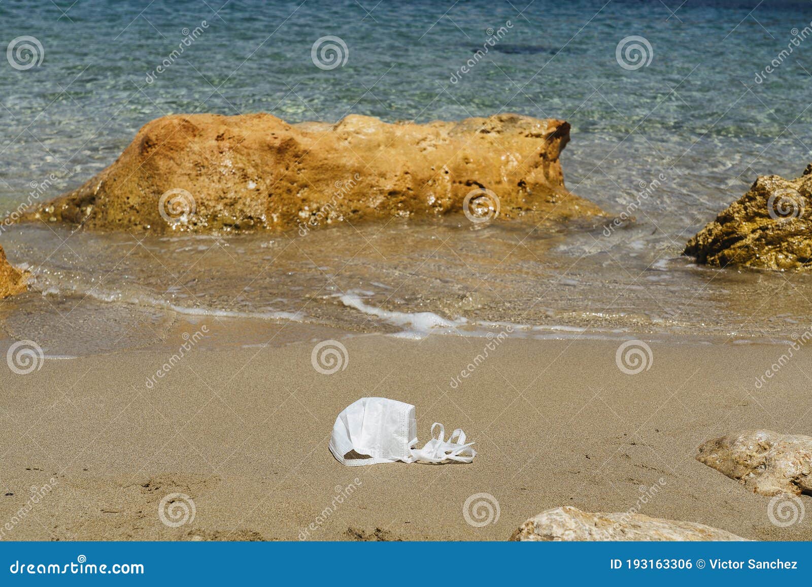 Beach Polluted with Face Mask of Covid. Environmental Contamination ...