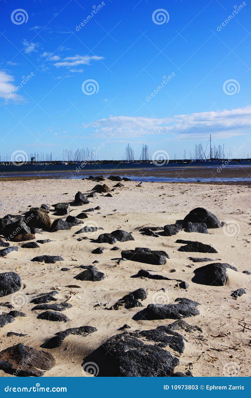 Beach with Rocks Leading into Water Stock Image - Image of rocks, beach ...
