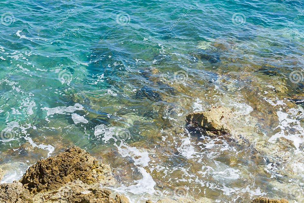 Beach with rocks in water stock photo. Image of coastline - 279107758